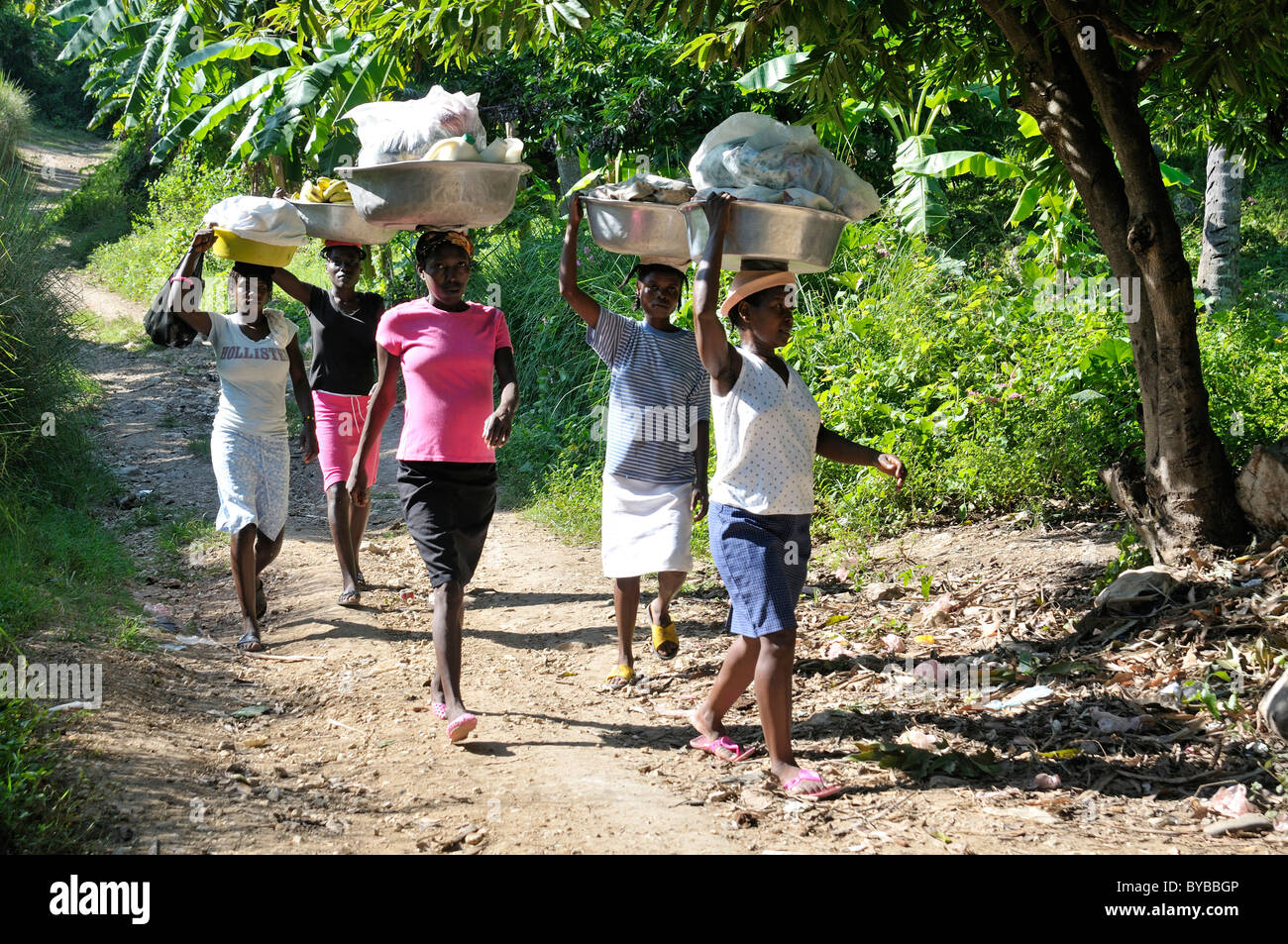 Women carrying clothes on their heads, on their way to the river to do ...