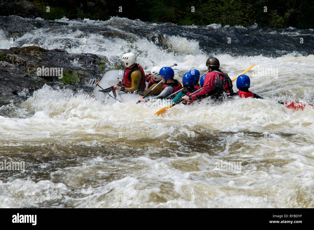 Group of people white water rafting Stock Photo - Alamy