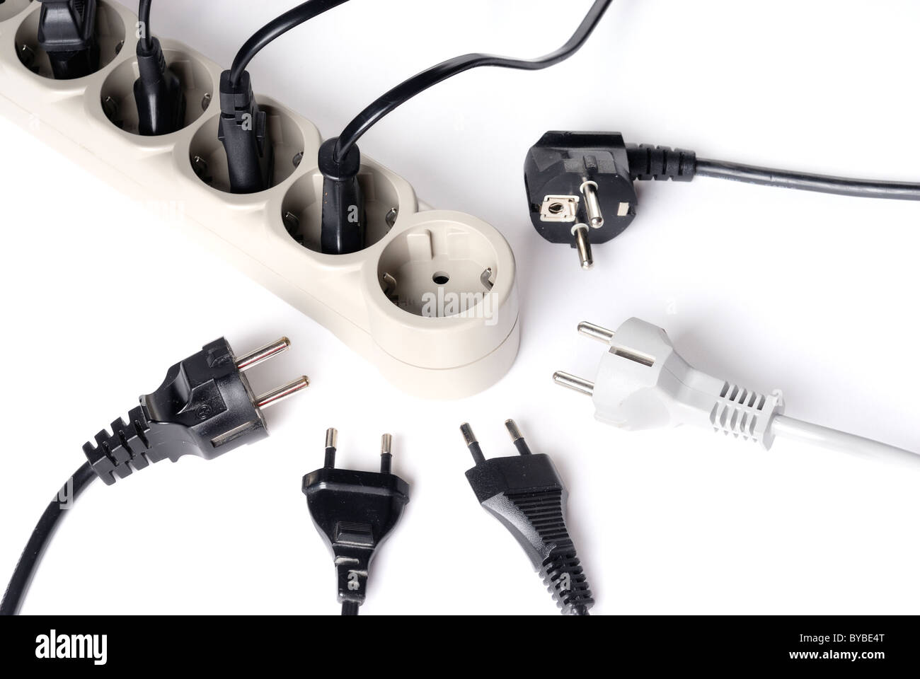 Many power supply plugs and only one free outlet isolated on white ...