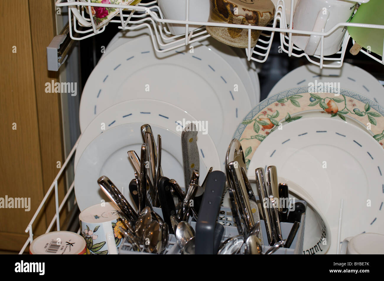 Dishwasher full of clean crockery and cutlery Stock Photo - Alamy