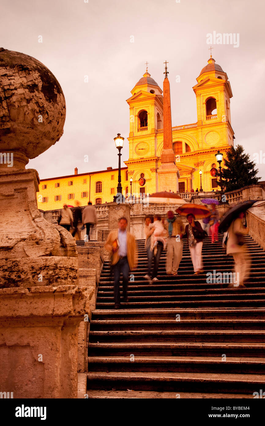 Evening rain at the Spanish Steps has everyone reaching for umbrellas ...