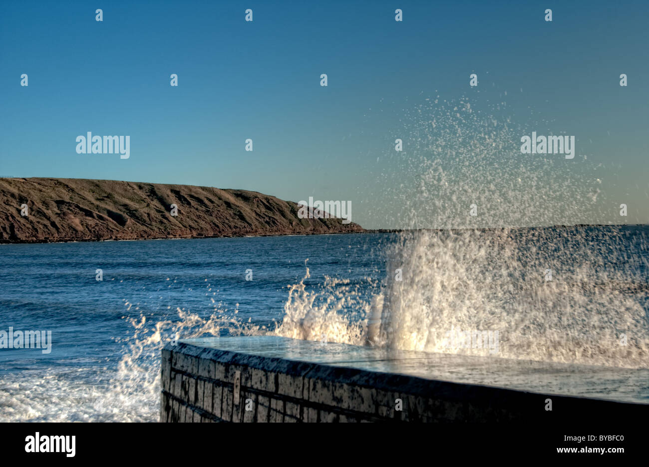 Sea wall splash Stock Photo - Alamy