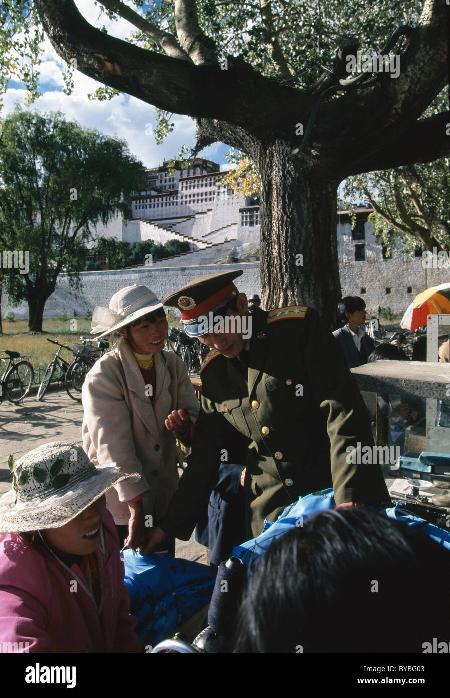 A Chinese Army soldier speaks with a Chinese street vendor below the ...