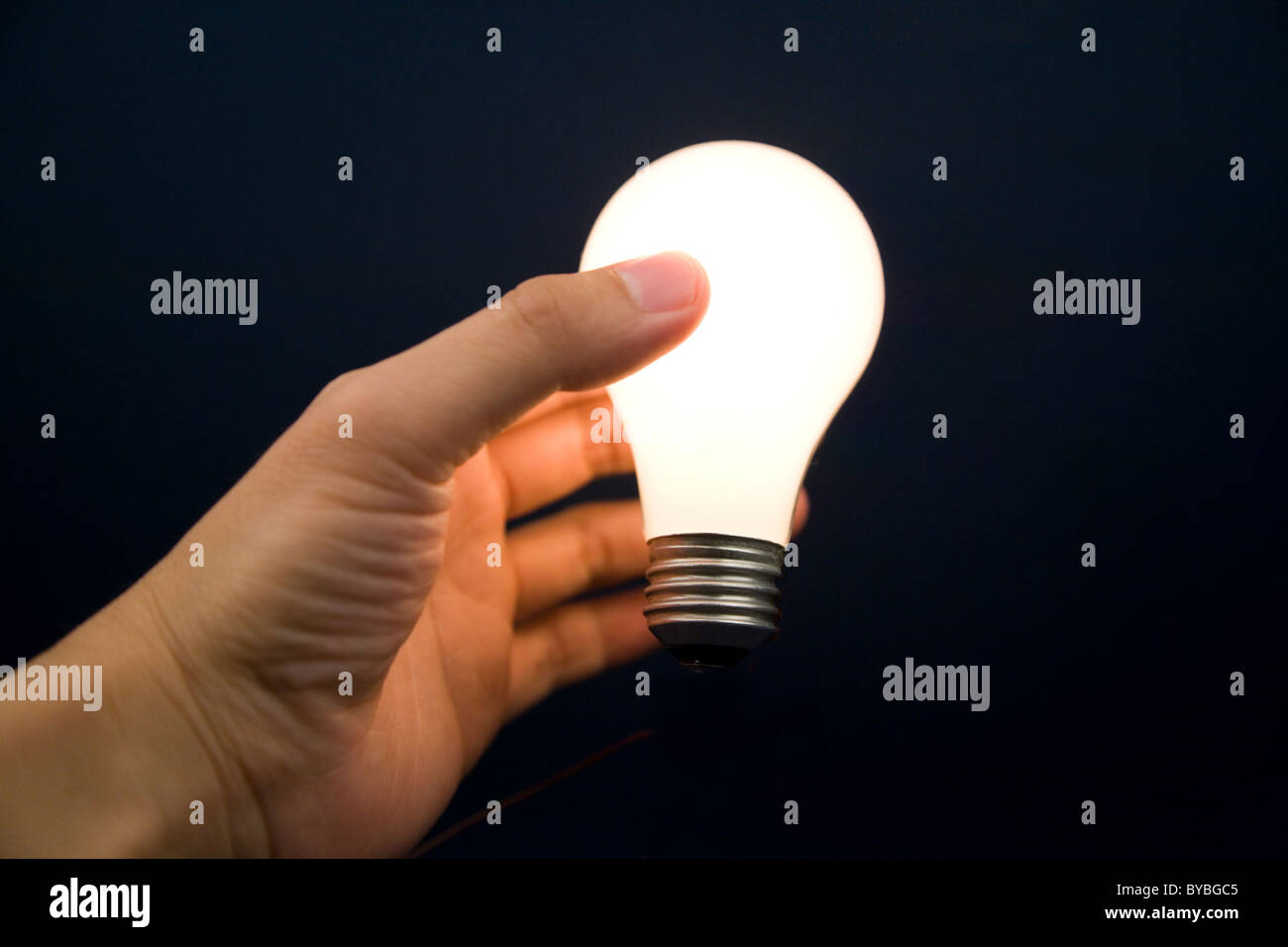 Hand holding a Bright Light Bulb, Concept of Inspiration, Ideas Stock ...