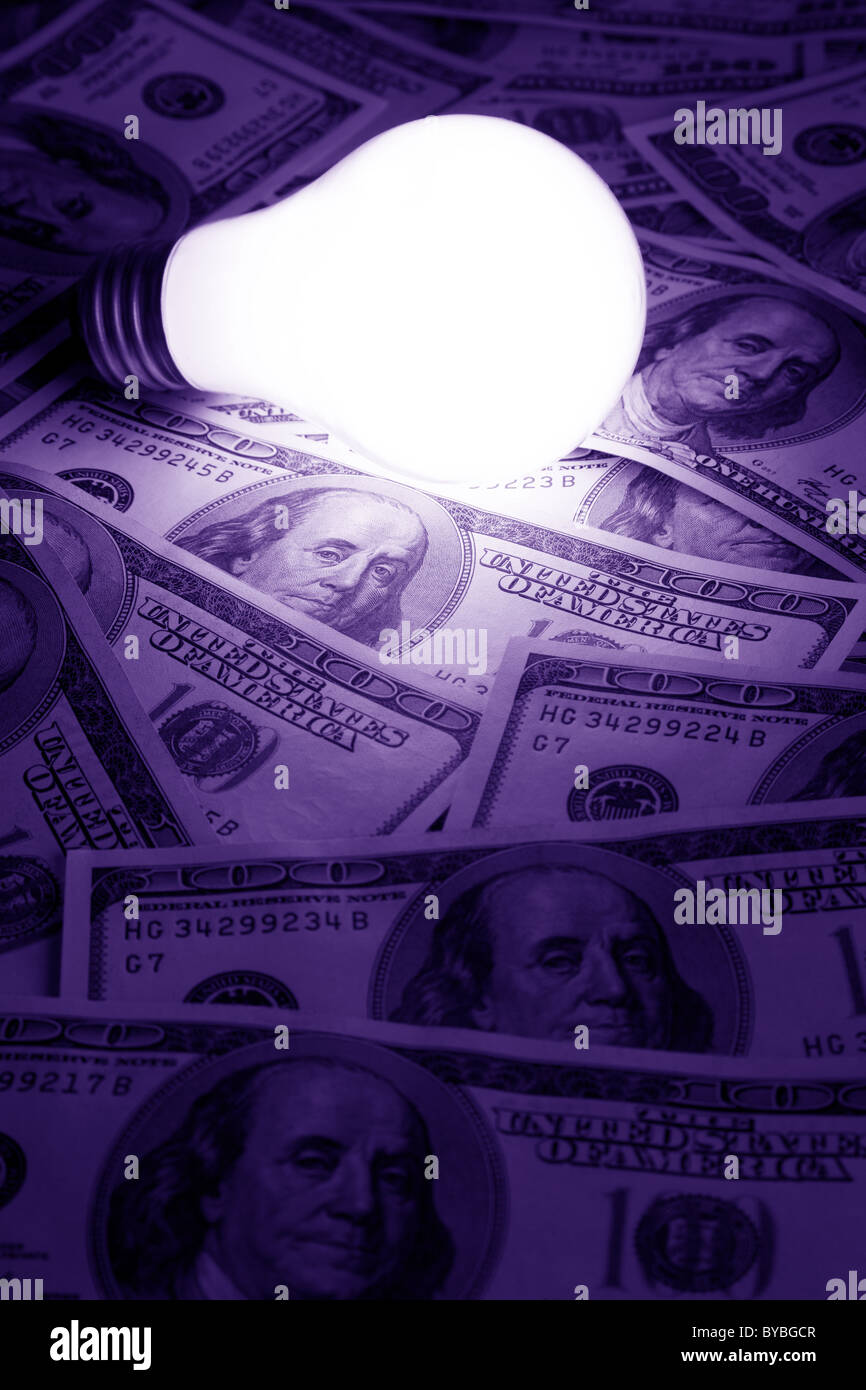 Bright Light Bulb and Dollar close up shot Stock Photo - Alamy