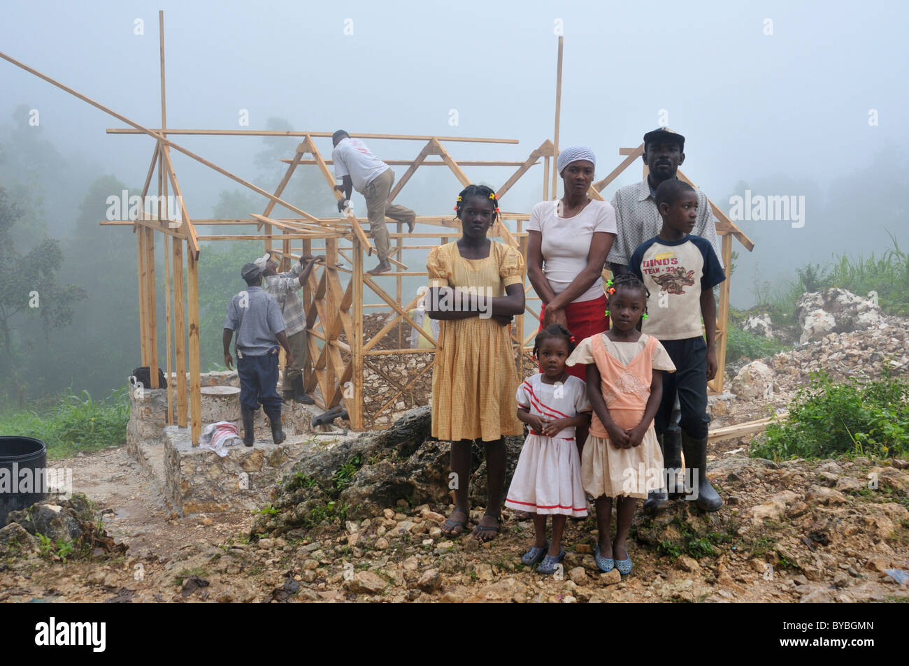 A family, victims of the earthquake in january 2010, next to their new ...