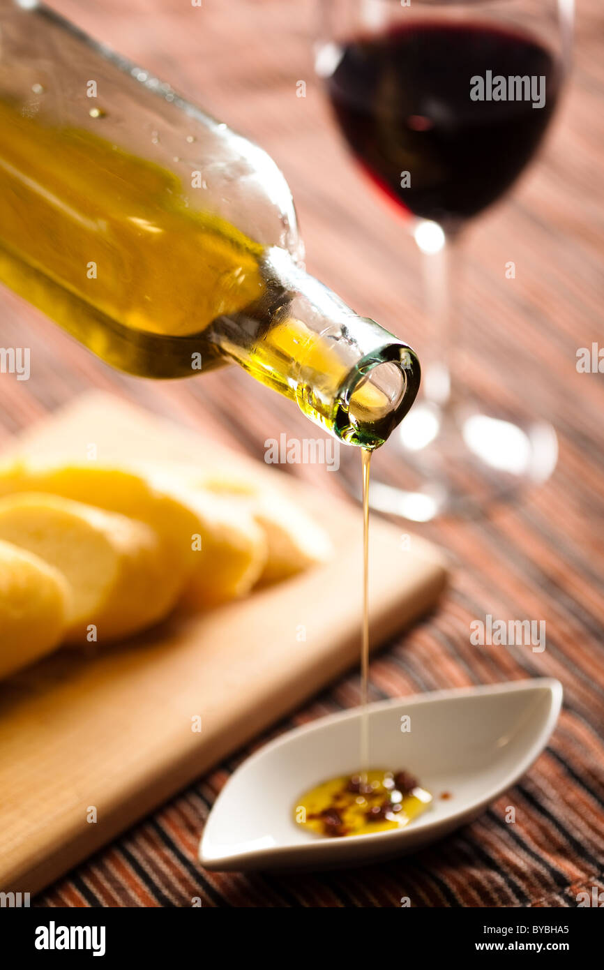 Olive oil poured over chopped sundried tomatoes Stock Photo - Alamy