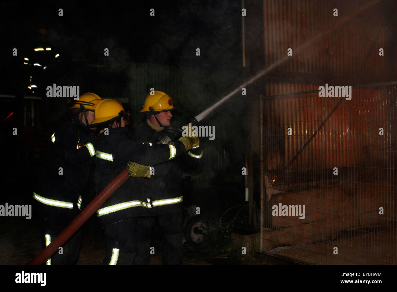 Firefighters tackle a farm fire at night Stock Photo - Alamy