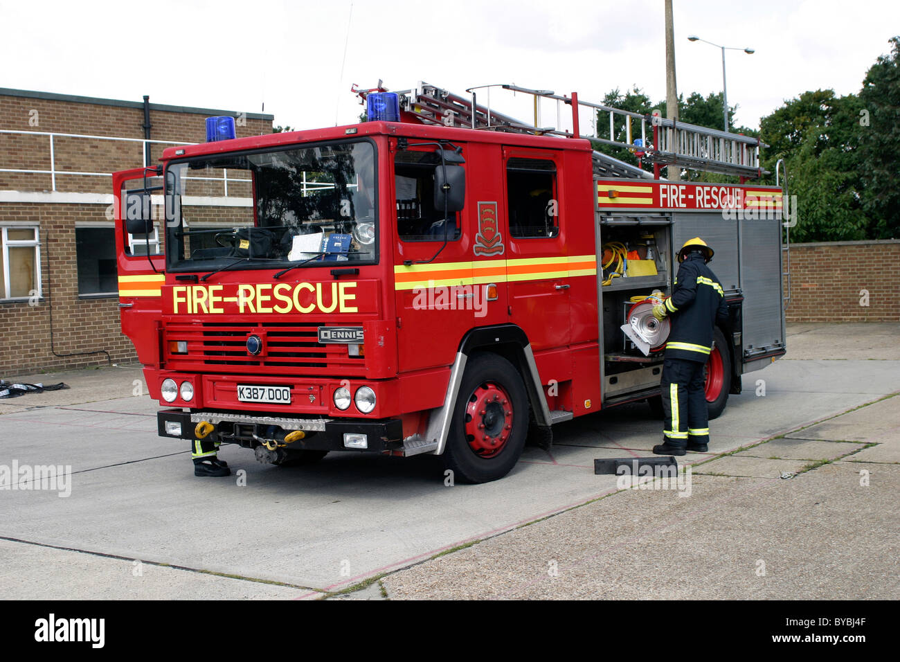 Firemen with fire engine at a fire station Stock Photo - Alamy