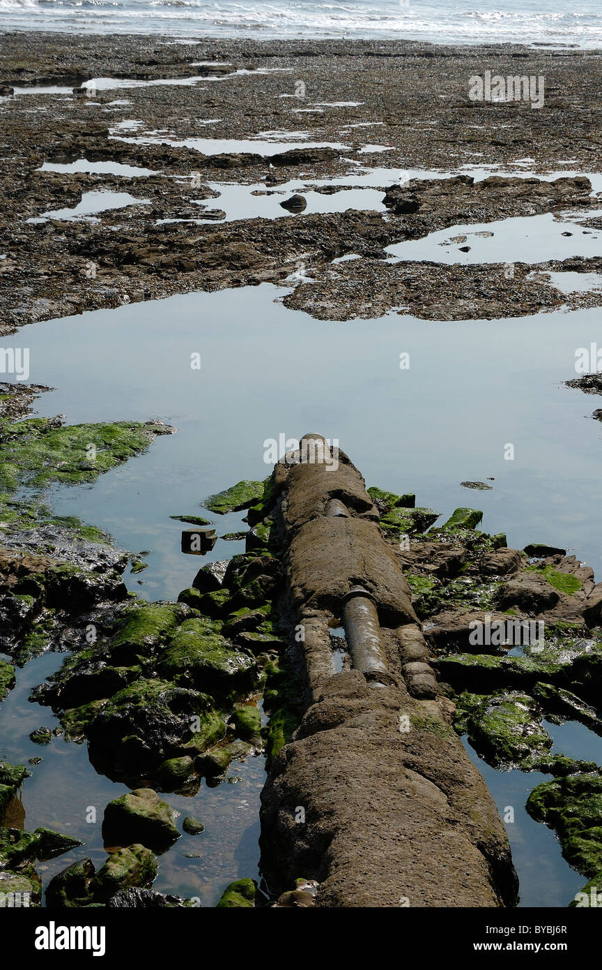 pipes leading into the sea england uk Stock Photo - Alamy