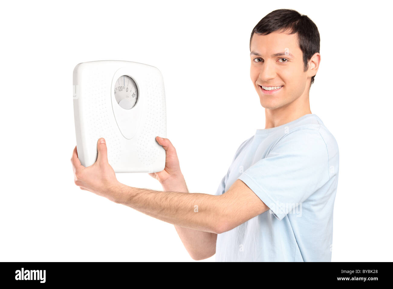 A happy young man holding a weight scale Stock Photo - Alamy