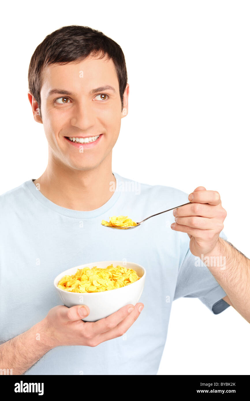 A young man eating cornflakes Stock Photo - Alamy