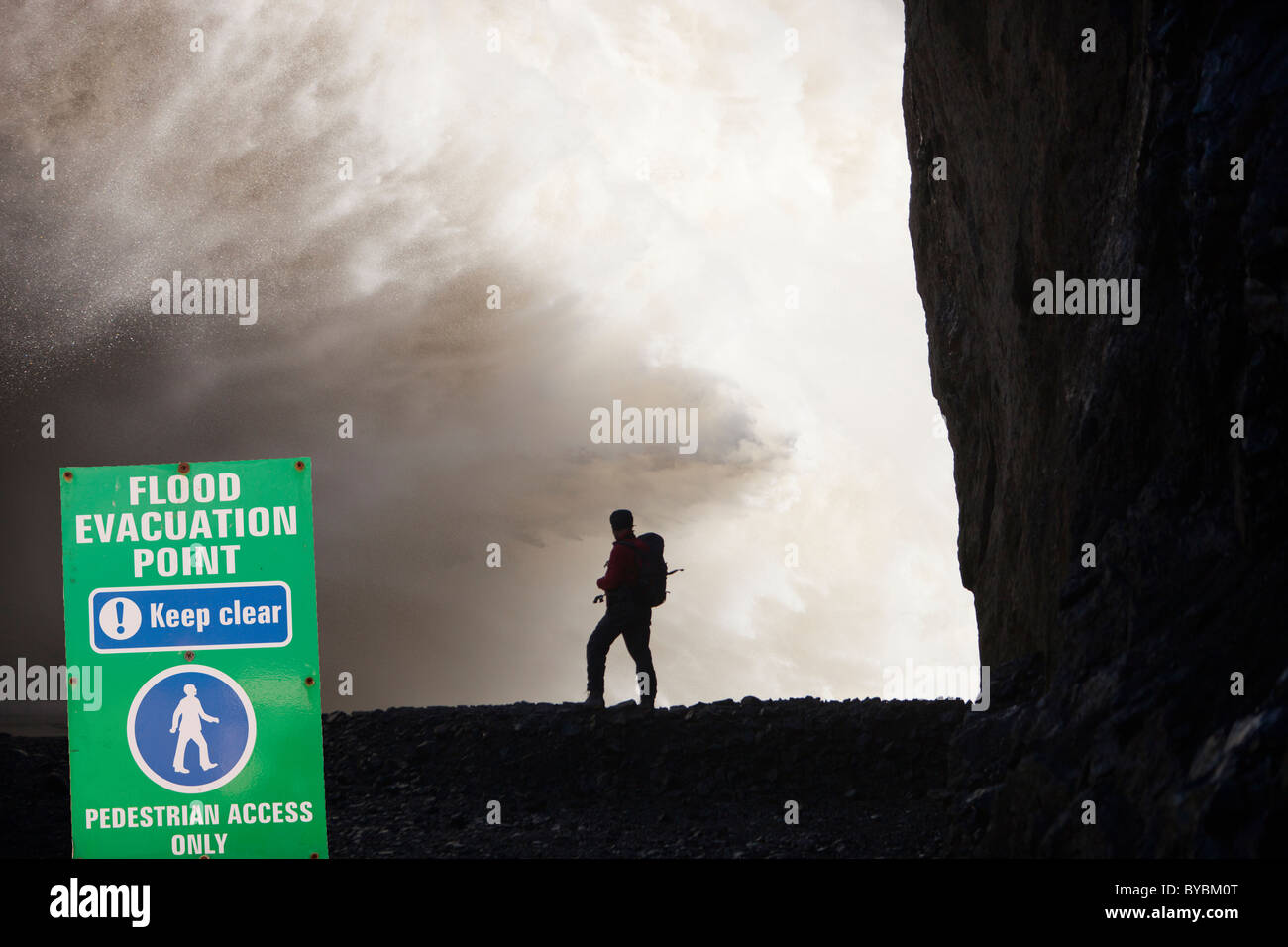A person crosses near the overflow from Karahnjukar dam and Halslon ...