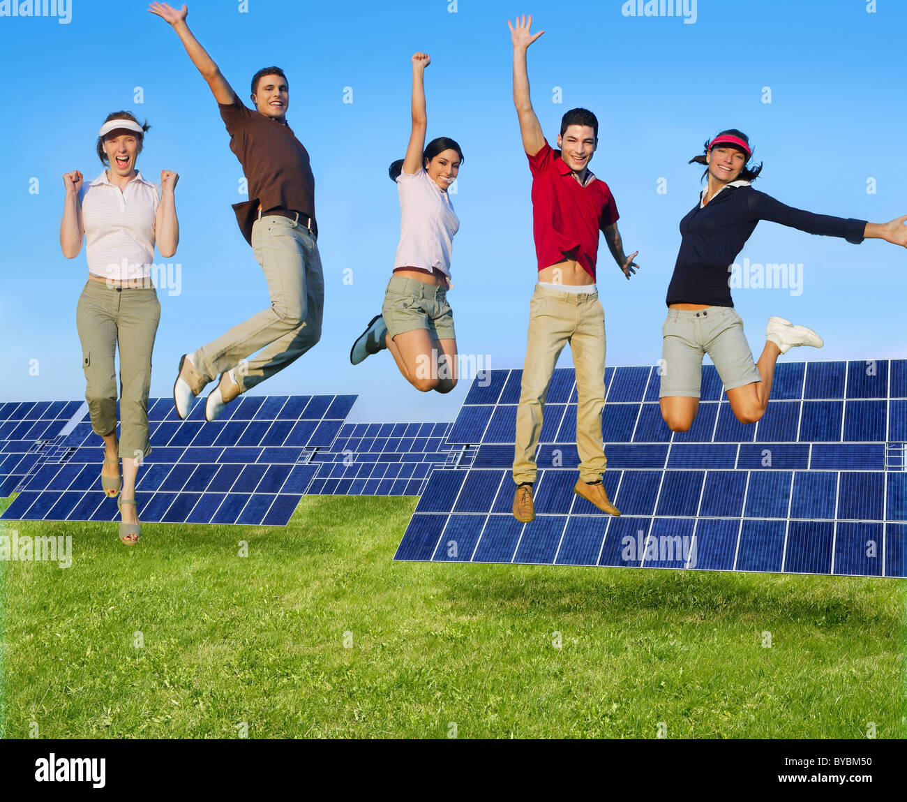 Jumping young people happy group green energy solar plates Stock Photo ...