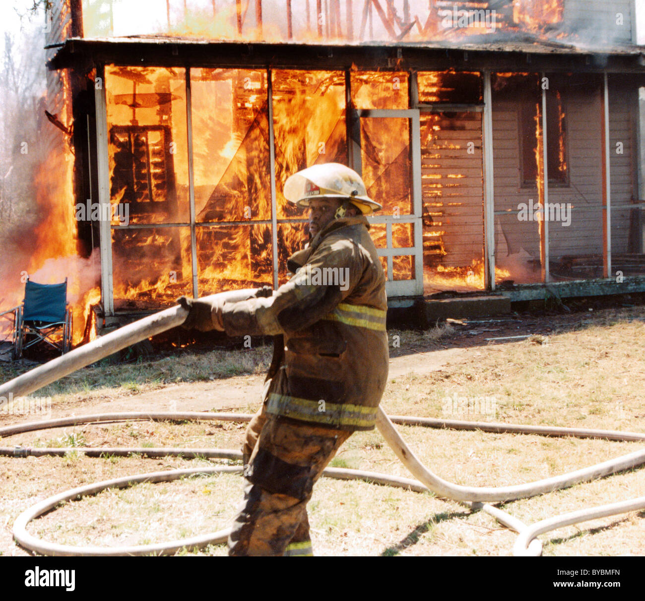 Firefighter stretches hose at a house fire in Glendale, Md Stock Photo ...