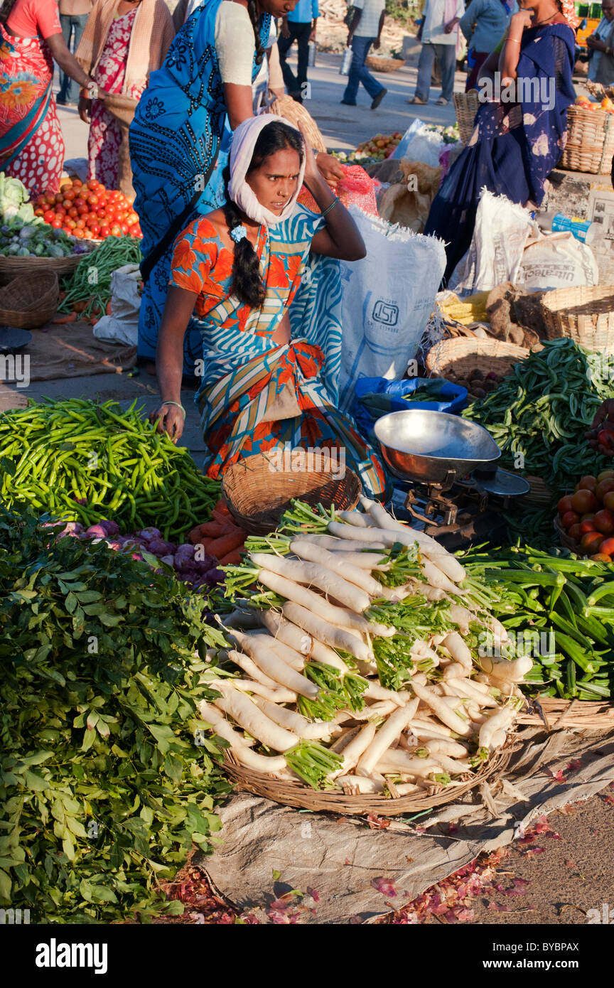 Indian woman selling radishes with other vegetables at a rural indian ...