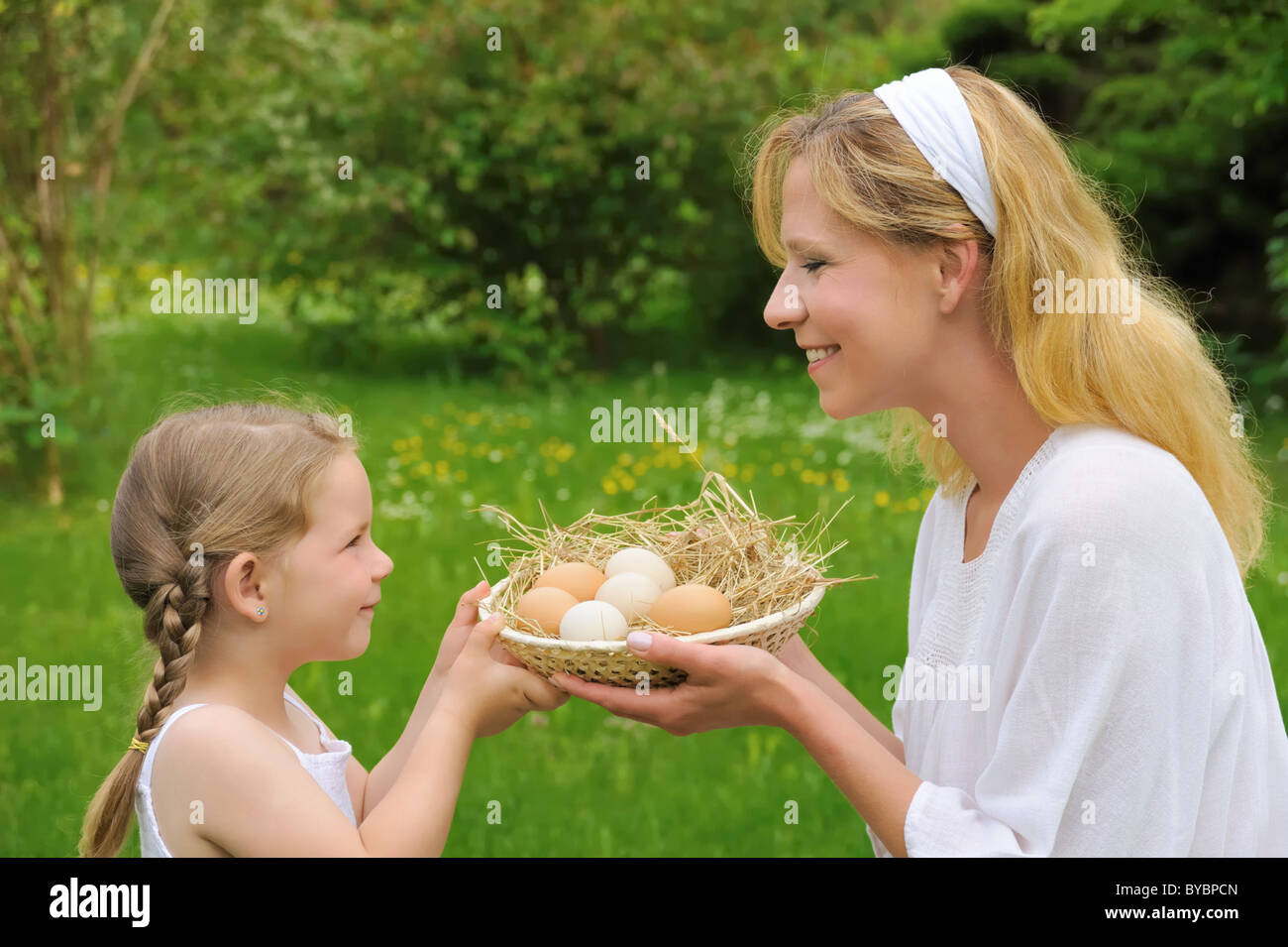 Mother and daughter holding fresh eggs Stock Photo - Alamy