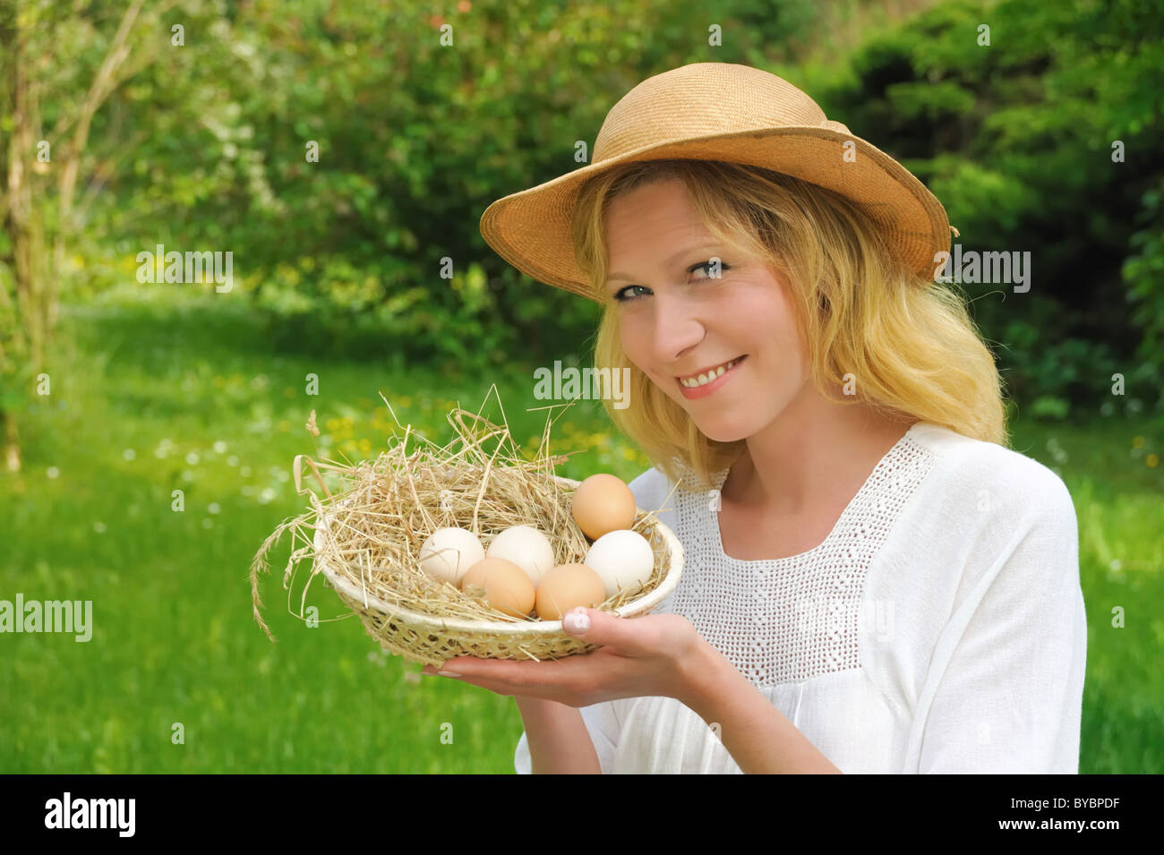 Happy young woman holding fresh eggs Stock Photo - Alamy