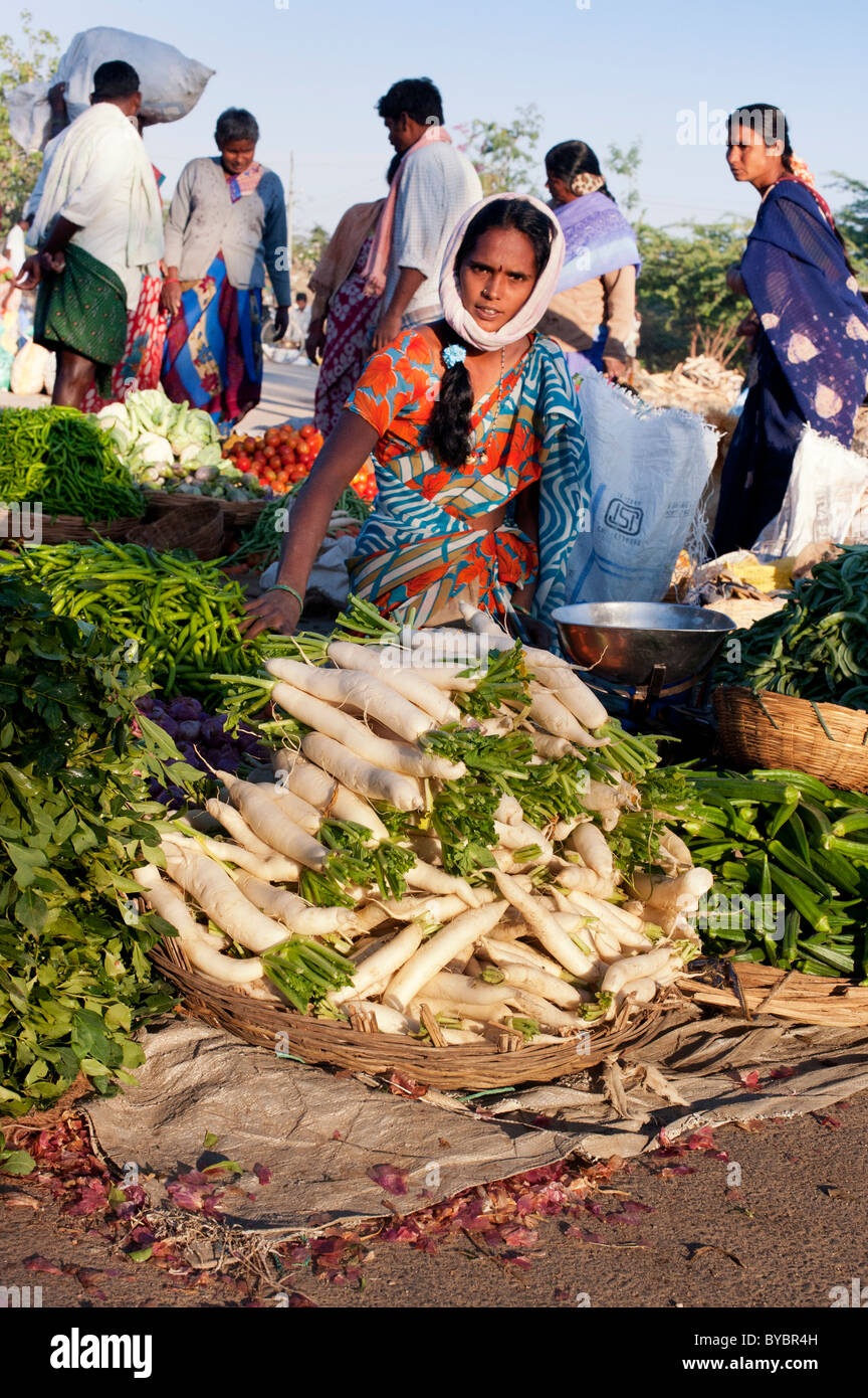 Indian woman selling radishes with other vegetables at a rural indian ...