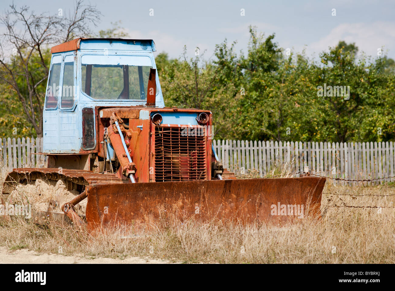 Abandoned and rusty bulldozer near a forest Stock Photo - Alamy