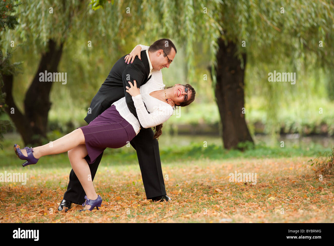 Happy young couple dancing outdoor in a park Stock Photo - Alamy