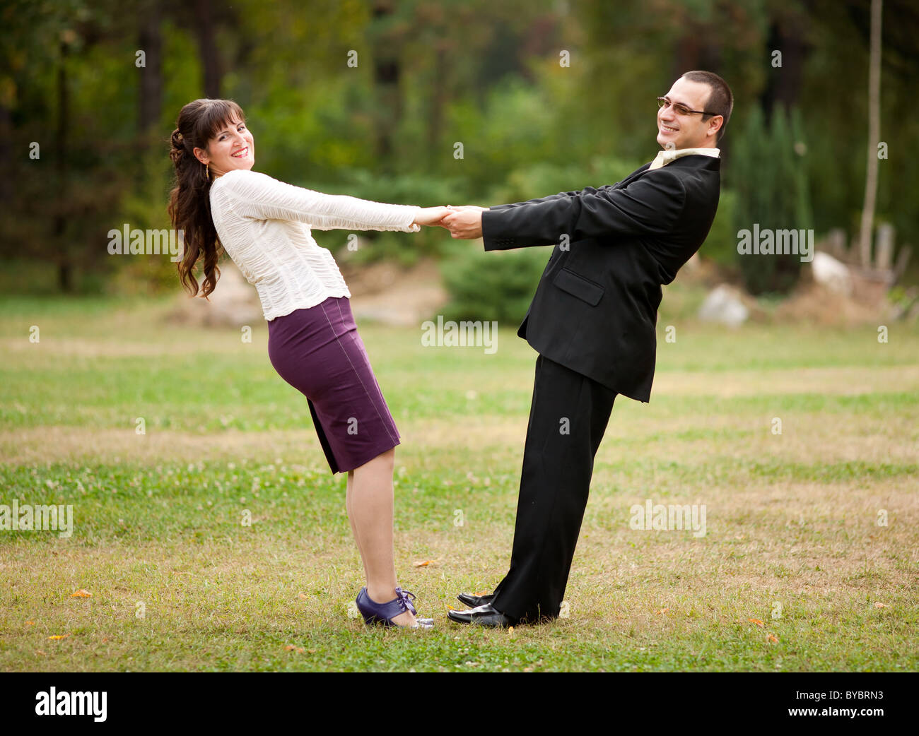 Happy young couple dancing outdoor in a park Stock Photo - Alamy