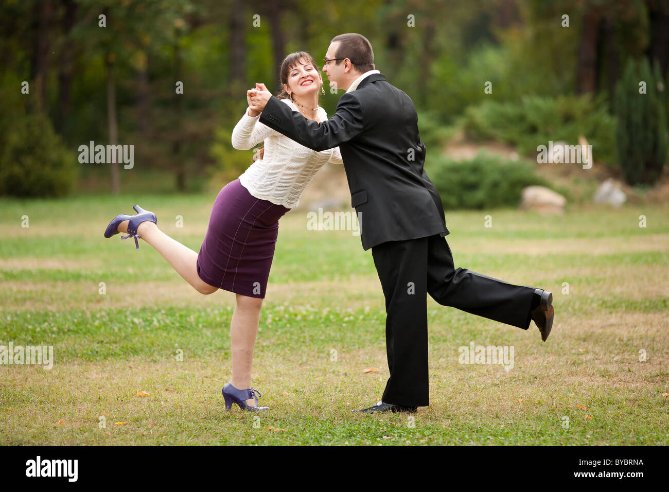 Happy young couple dancing outdoor in a park Stock Photo - Alamy