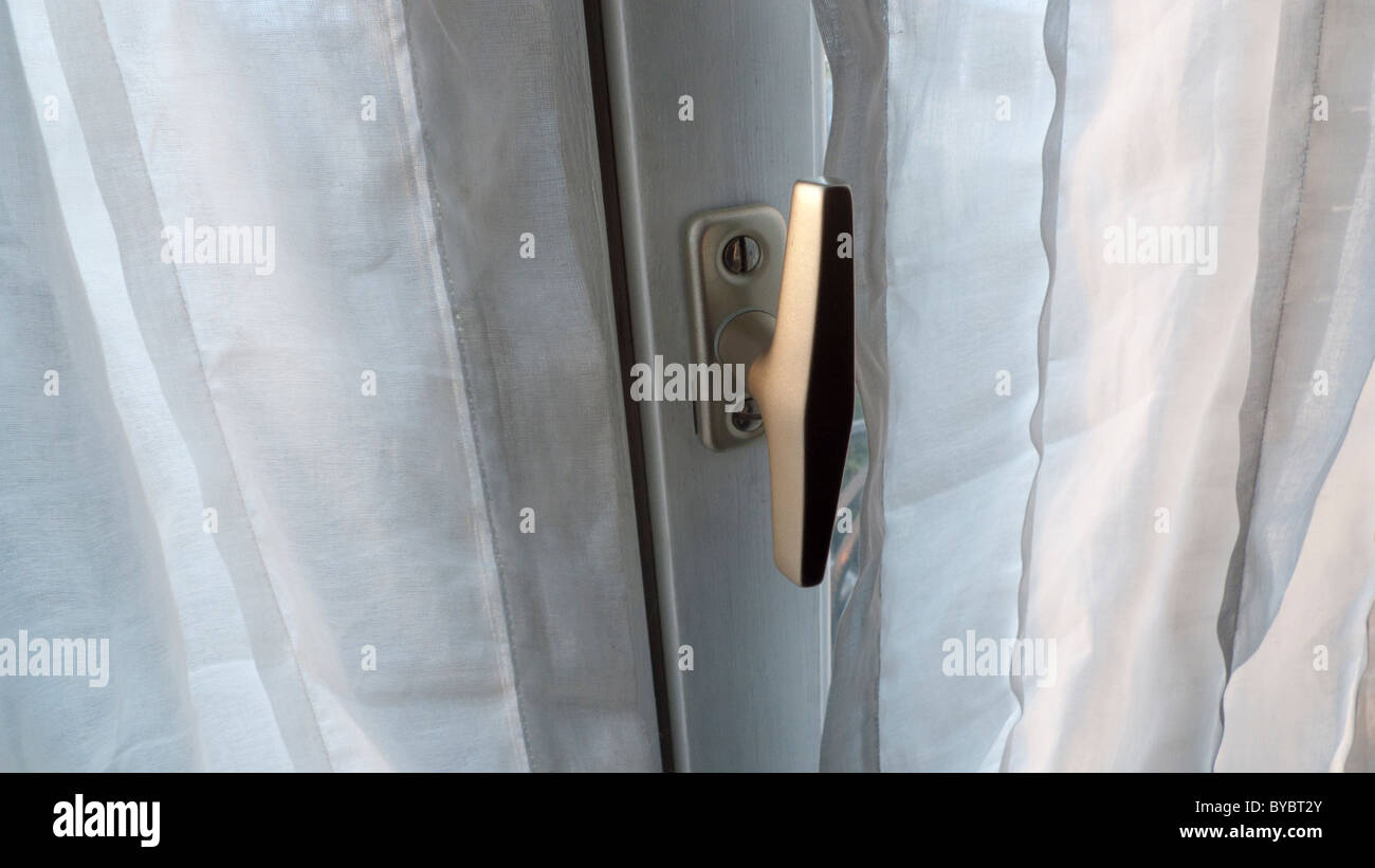 Window latch with net curtains Stock Photo - Alamy