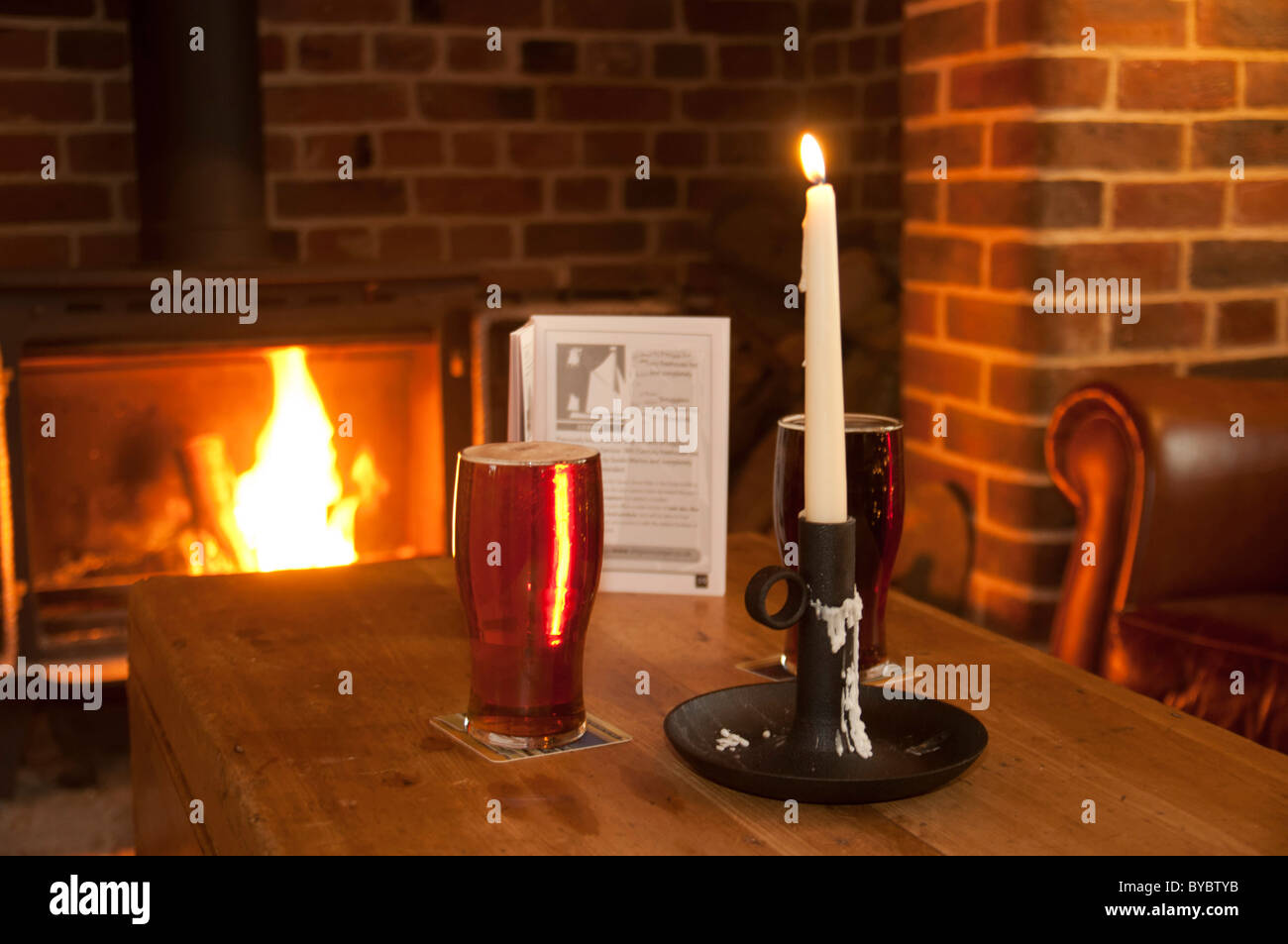 pint of beer by fire side Stock Photo - Alamy
