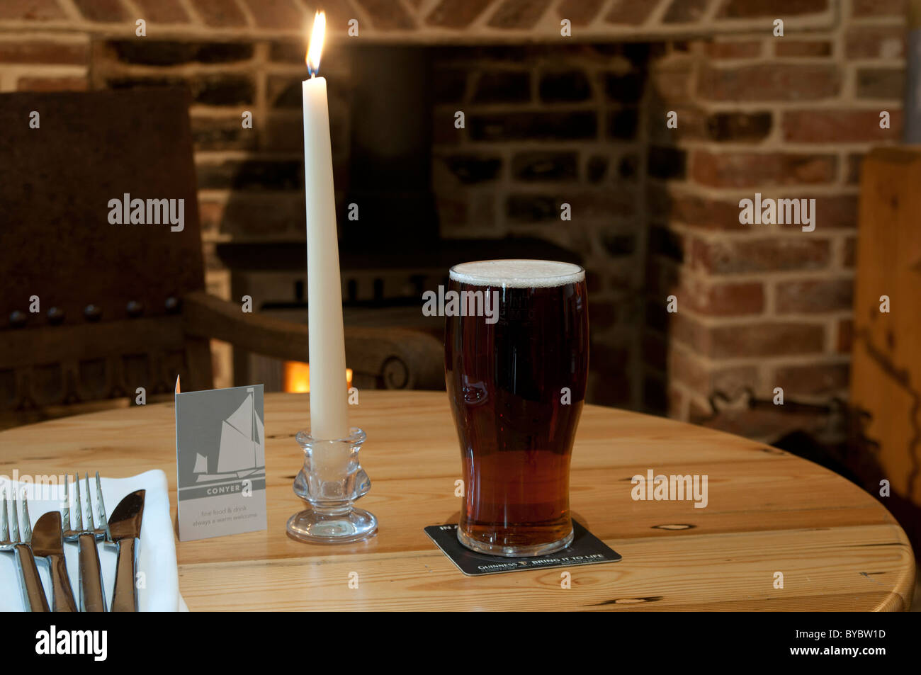 pint of beer by fire side Stock Photo - Alamy