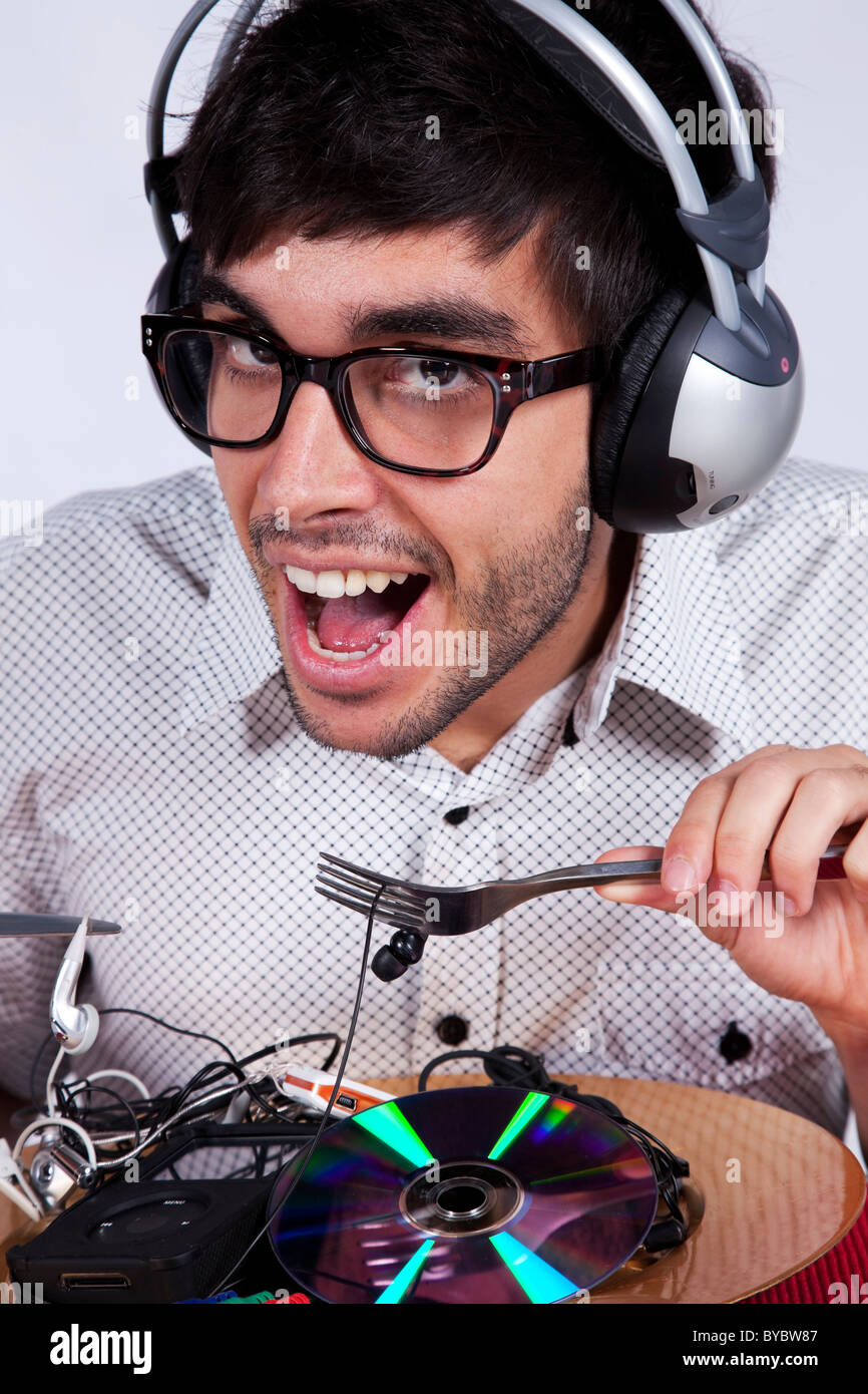 Crazy young man eating music at his dinner plate Stock Photo - Alamy