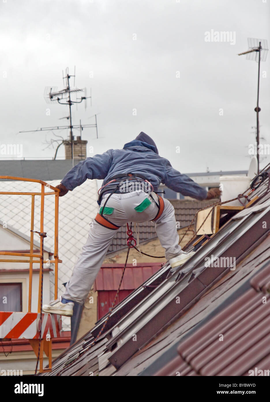 Man working on roof Stock Photo - Alamy