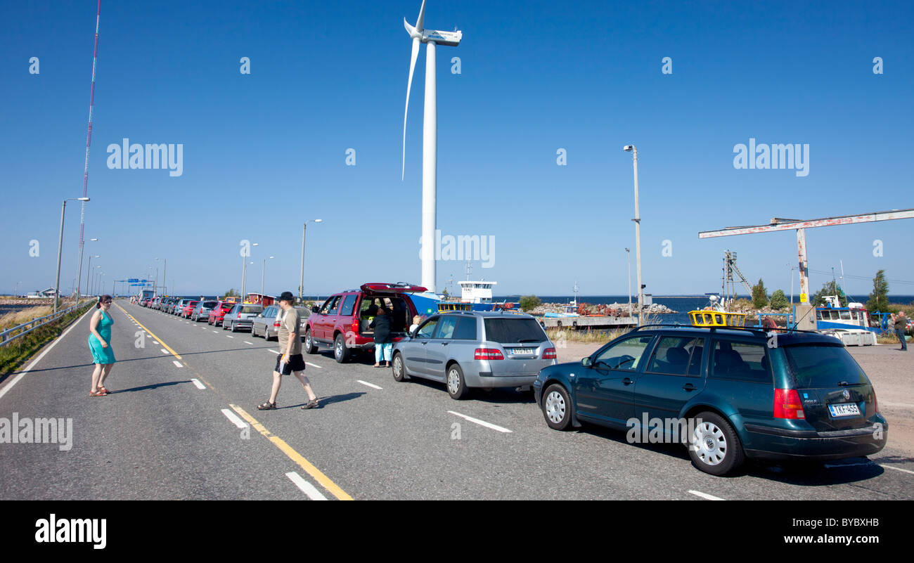 Tourists queuing to the car ferry , which transports them to the ...