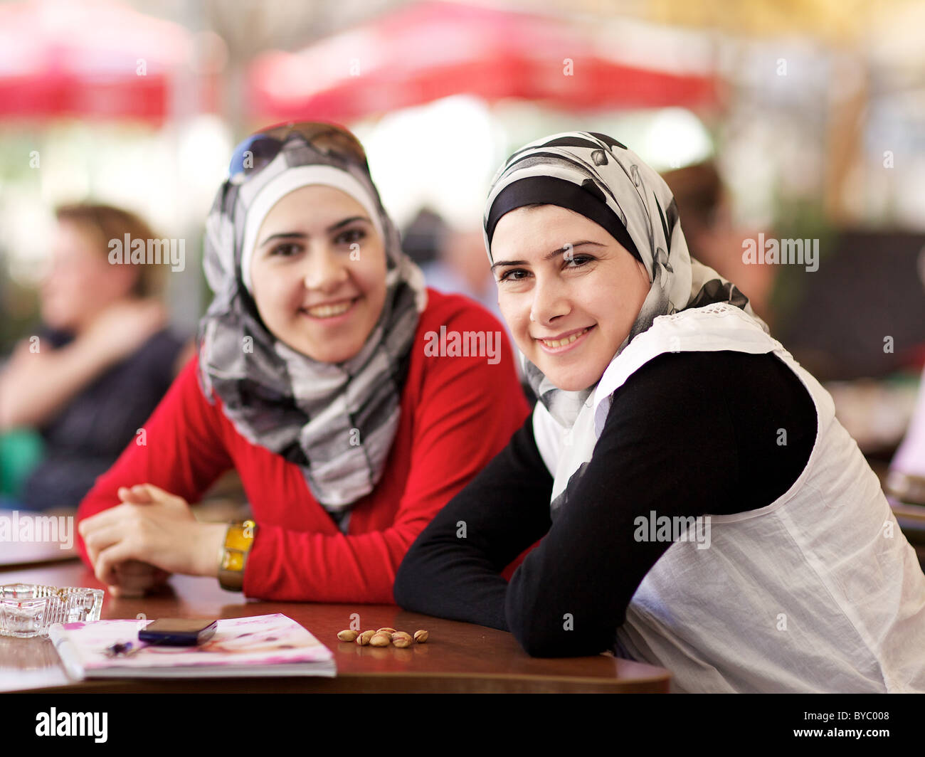 Syrian girls relaxing in Aleppo cafe in front of Aleppo Citadel, Syria ...
