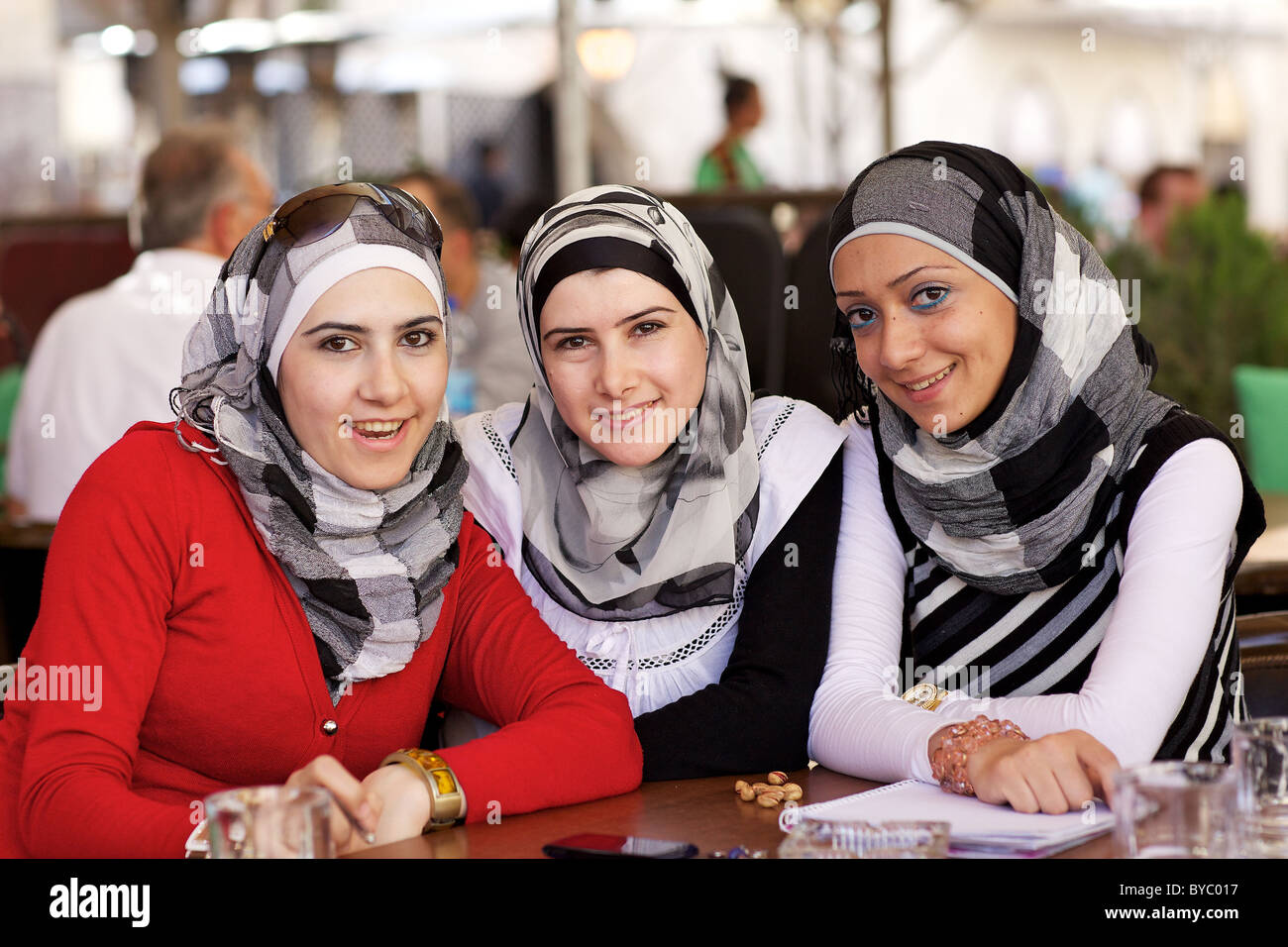 Three Syrian Girls Relaxing In Aleppo Cafe In Front Of Aleppo Citadel