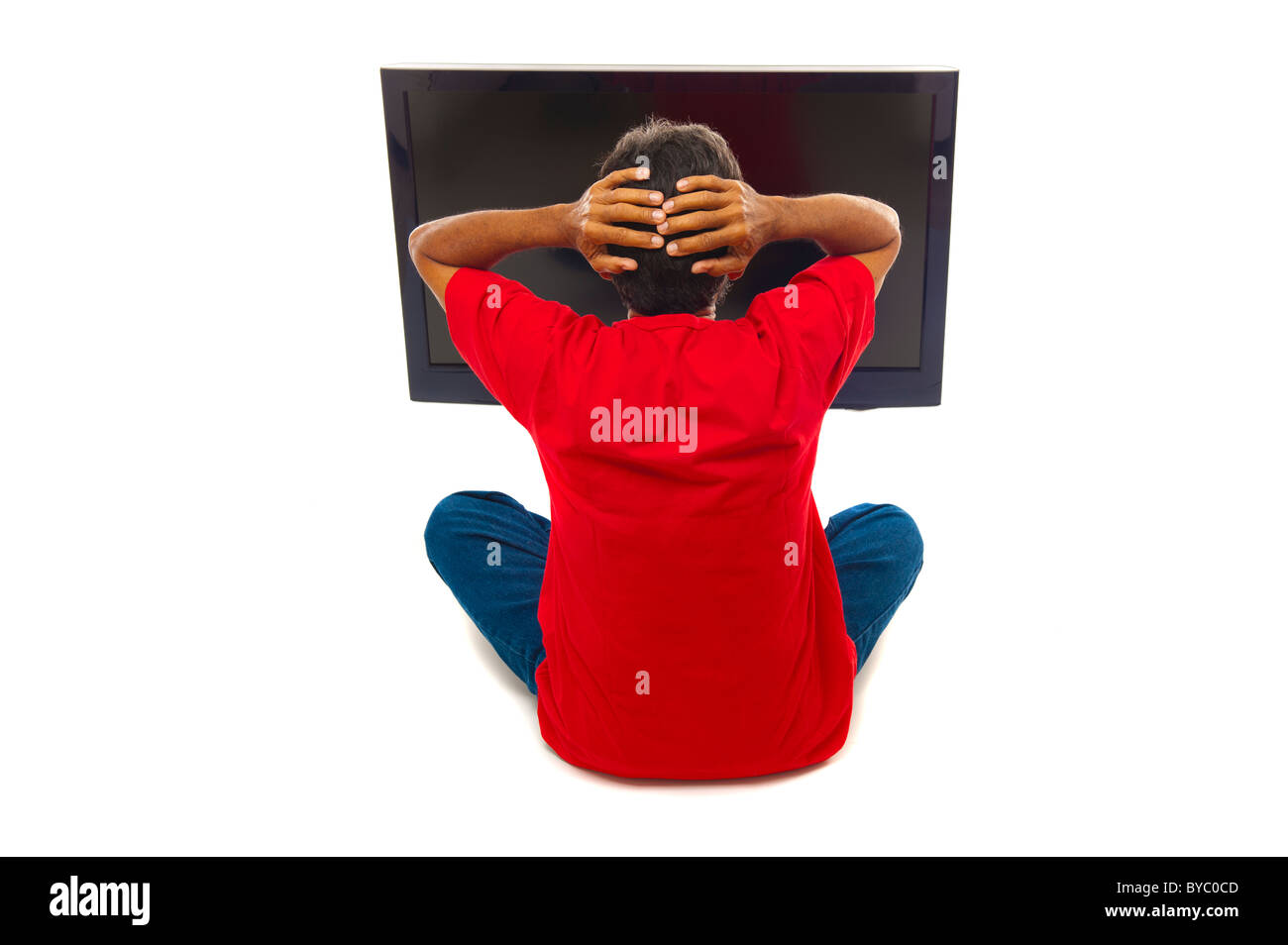 Man watching tv with hands on the head Stock Photo - Alamy