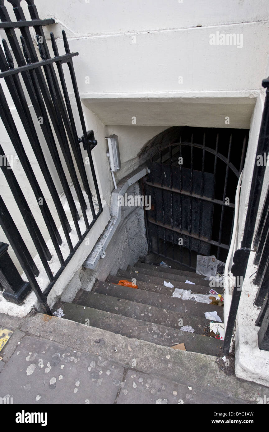 Steps leading down to a barred cellar entrance. Photograph by Gordon ...