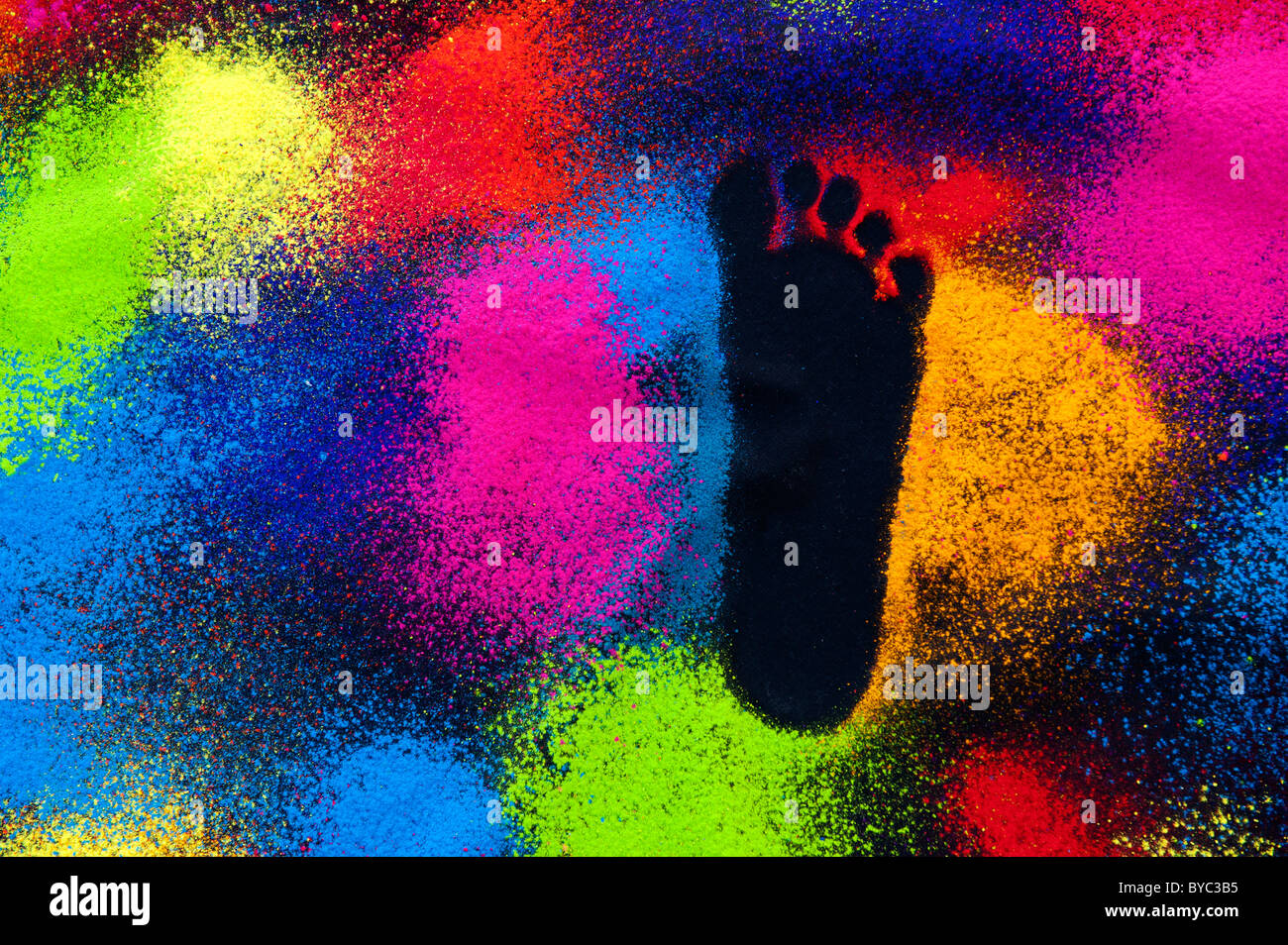 Childs black footprint on coloured powder. India Stock Photo - Alamy