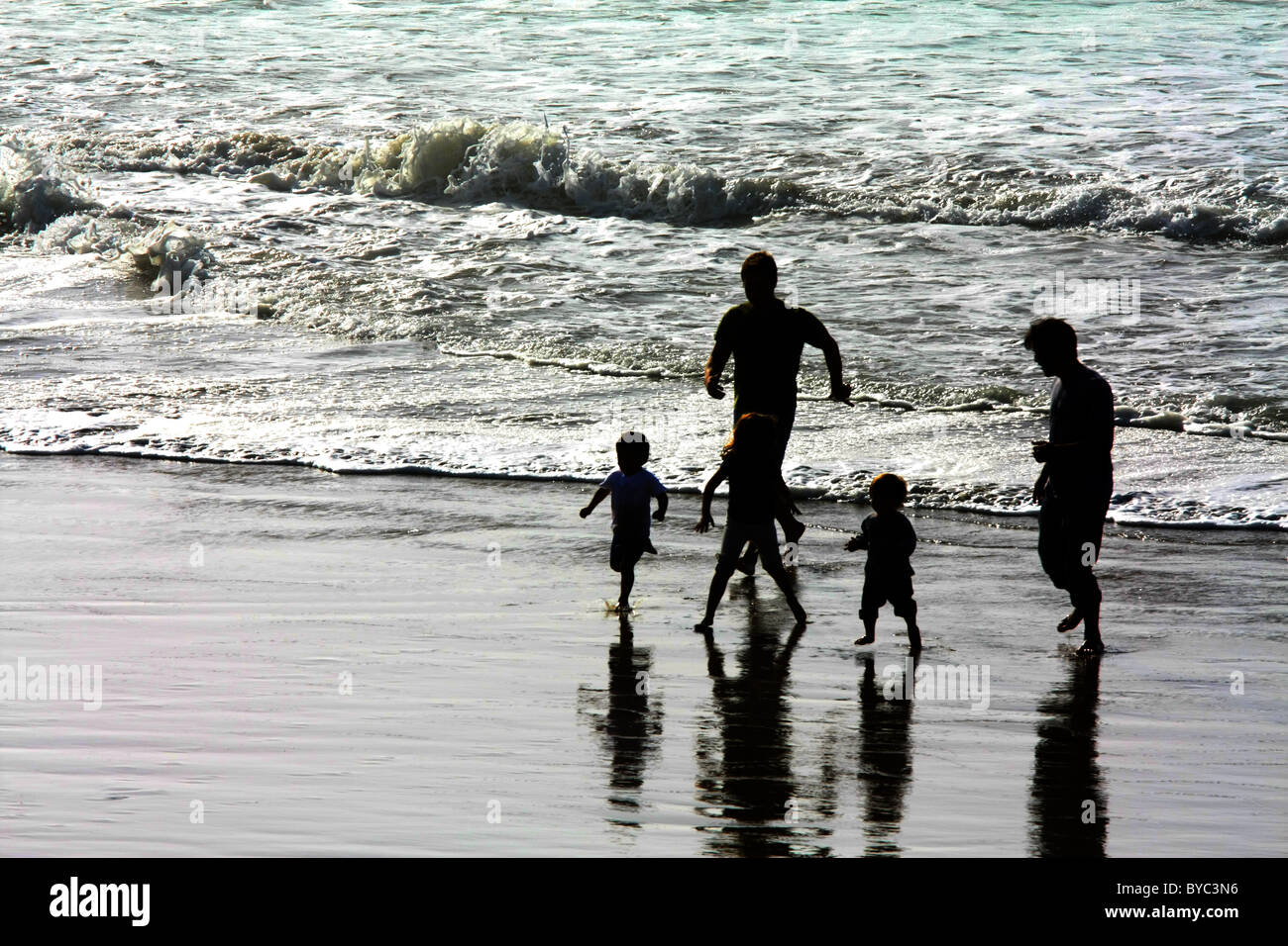 Two fathers and three preschool children walking, playing, and laughing ...