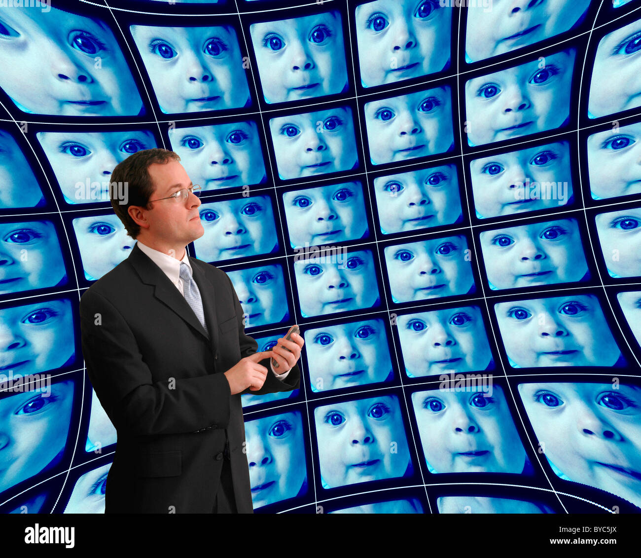 Man in suit monitoring babies on distorted bluish video screens Stock ...