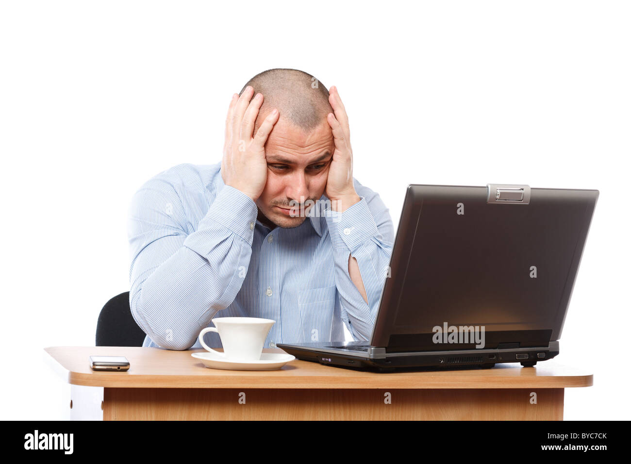 Tired and stressed young businessman working at his computer Stock ...