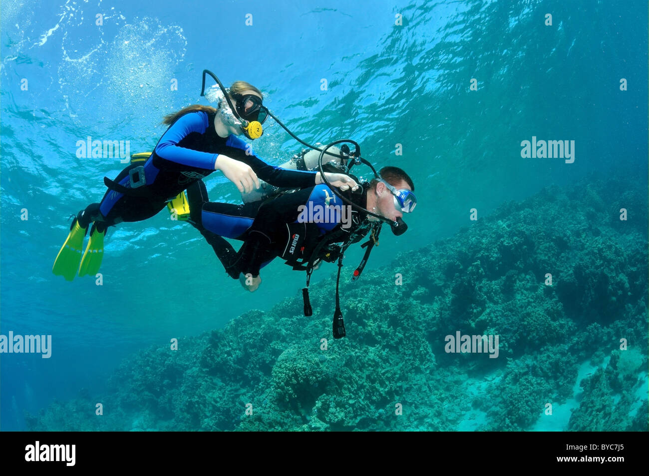 Scuba diver shows the child the underwater world Stock Photo - Alamy