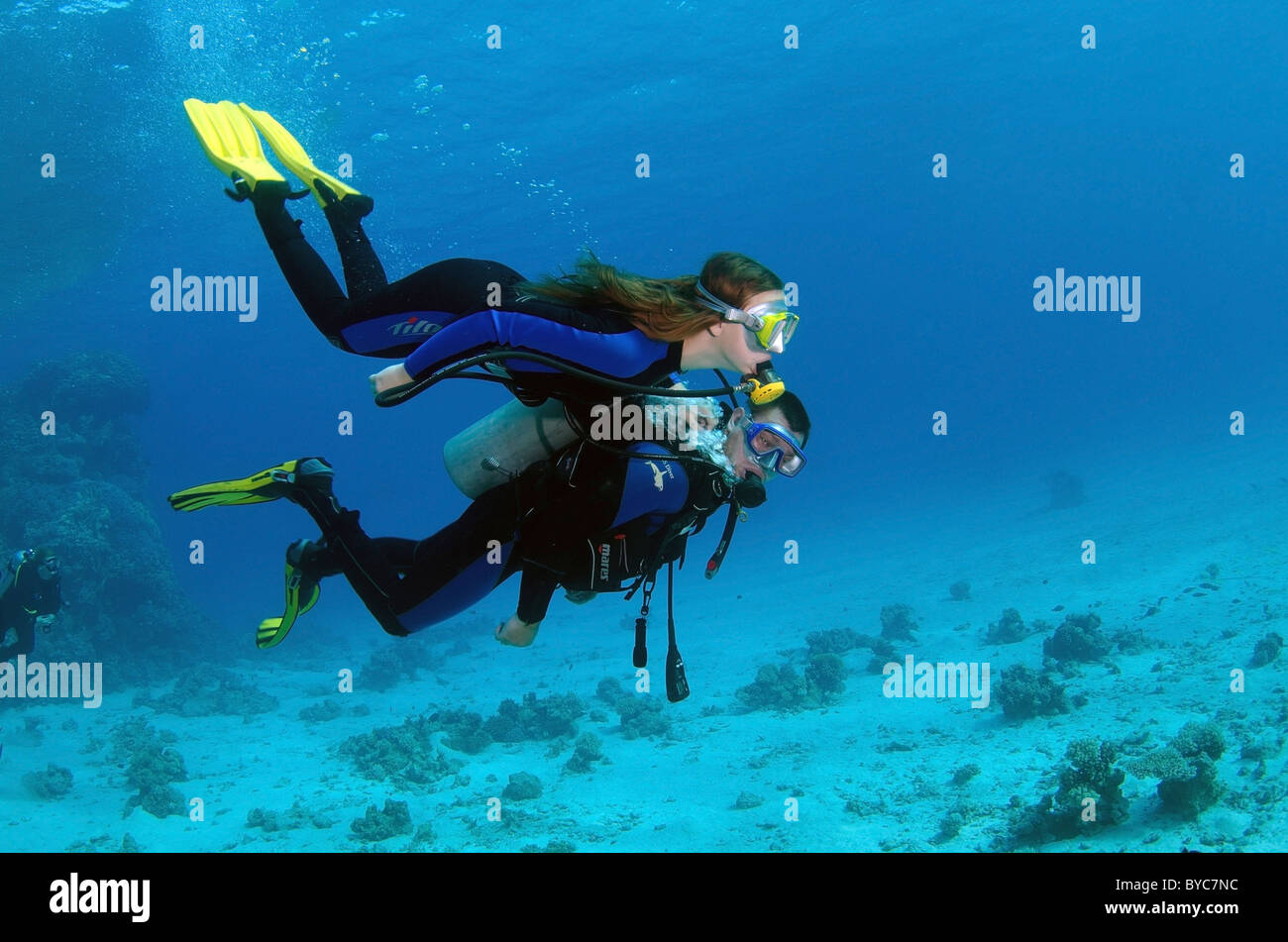 Scuba diver shows the child the underwater world Stock Photo - Alamy