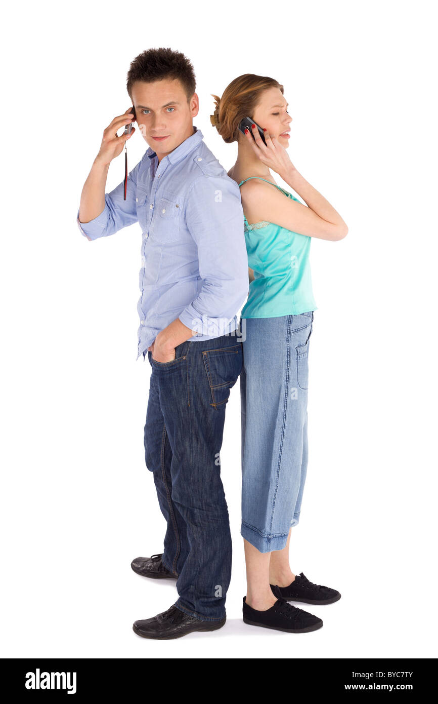 Young attractive casual couple standing back to back, talking on the ...