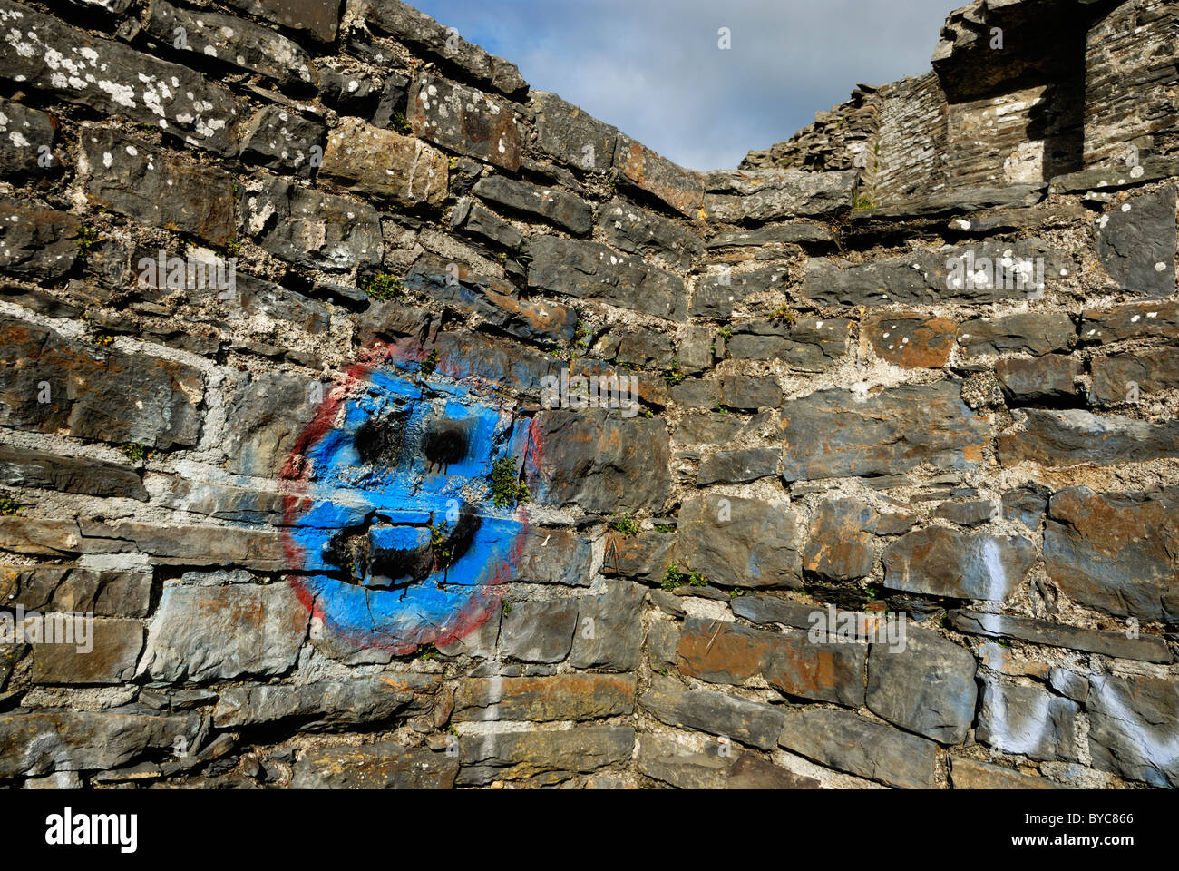 Blue smiley face graffiti on Aberystwyth castle wall, Wales Stock Photo ...