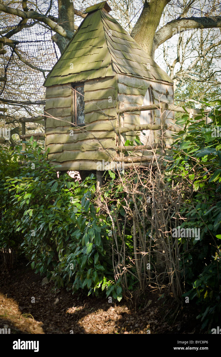 A wooden tree house with leaded windows Stock Photo - Alamy
