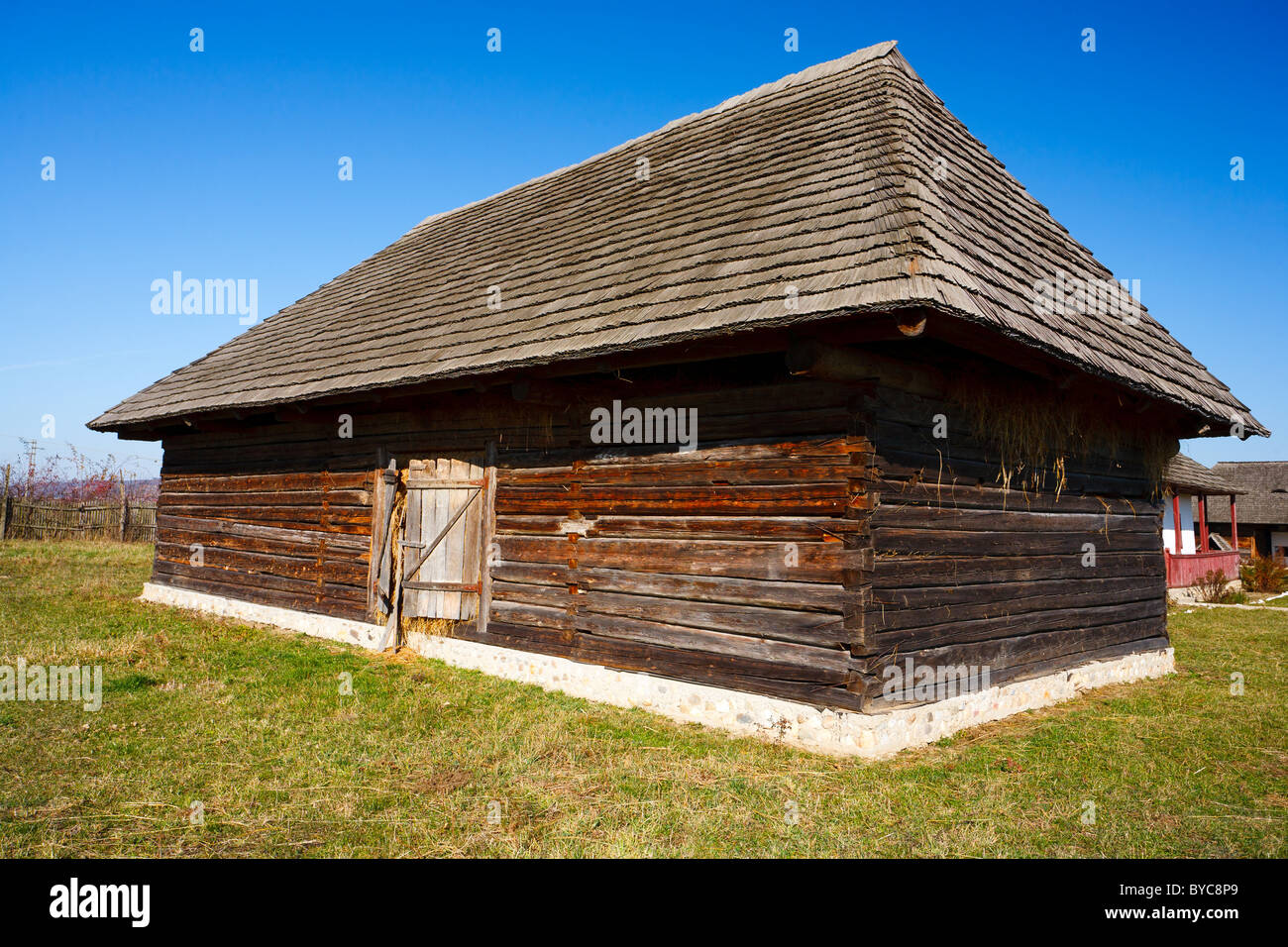 Old traditional Romanian barn or shack under blue sky - this is part of ...
