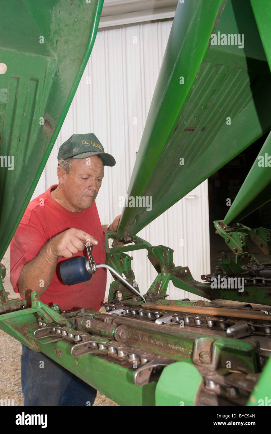 Dickinson Farm man oiling Corn Picker Stock Photo - Alamy