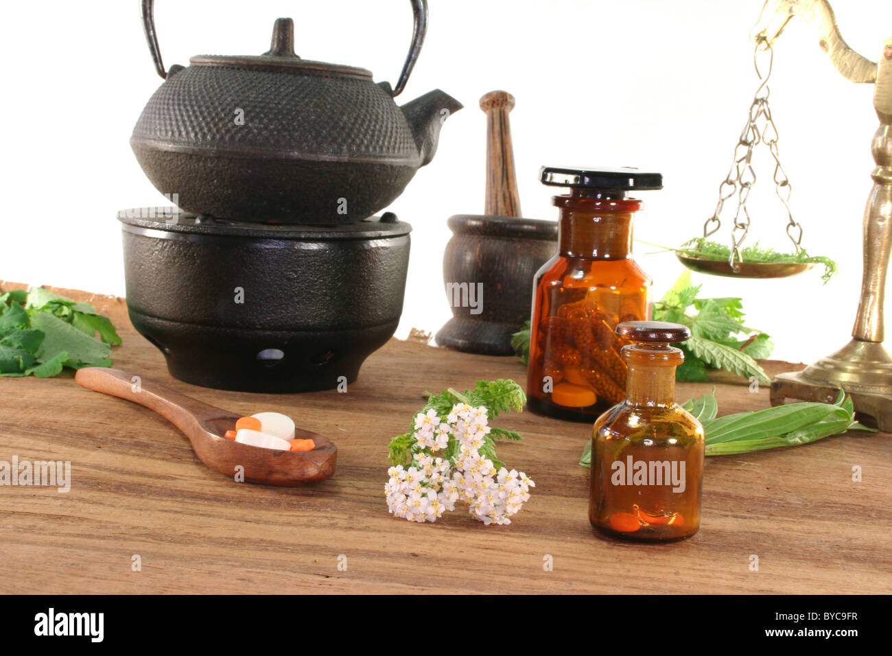 Pharmacists scale with mortar, tea kettle, bottle pharmacist and fresh ...