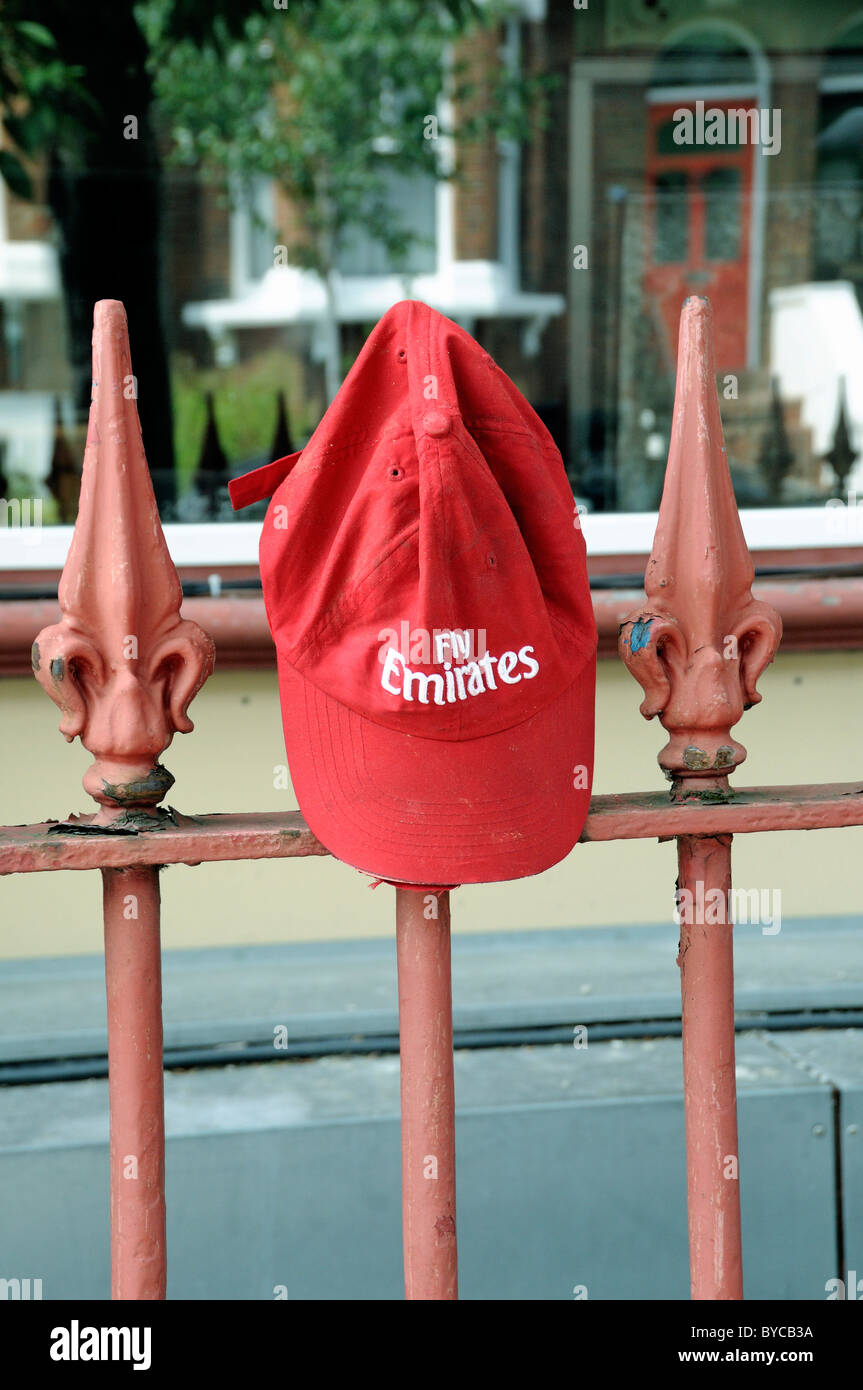 Red Fly Emirates baseball cap hanging on railing in Highbury London ...